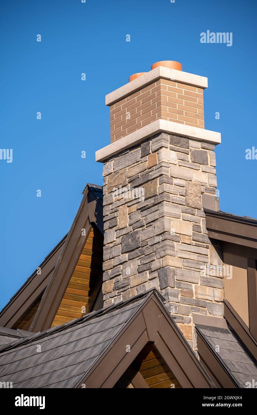 Stone chimny on a modern luxury home in Calgary Stock Photo - Alamy
