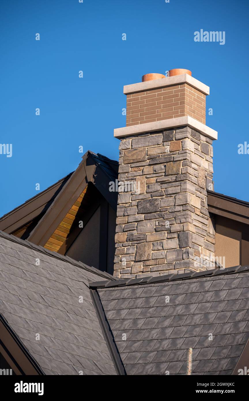 Stone chimny on a modern luxury home in Calgary Stock Photo - Alamy