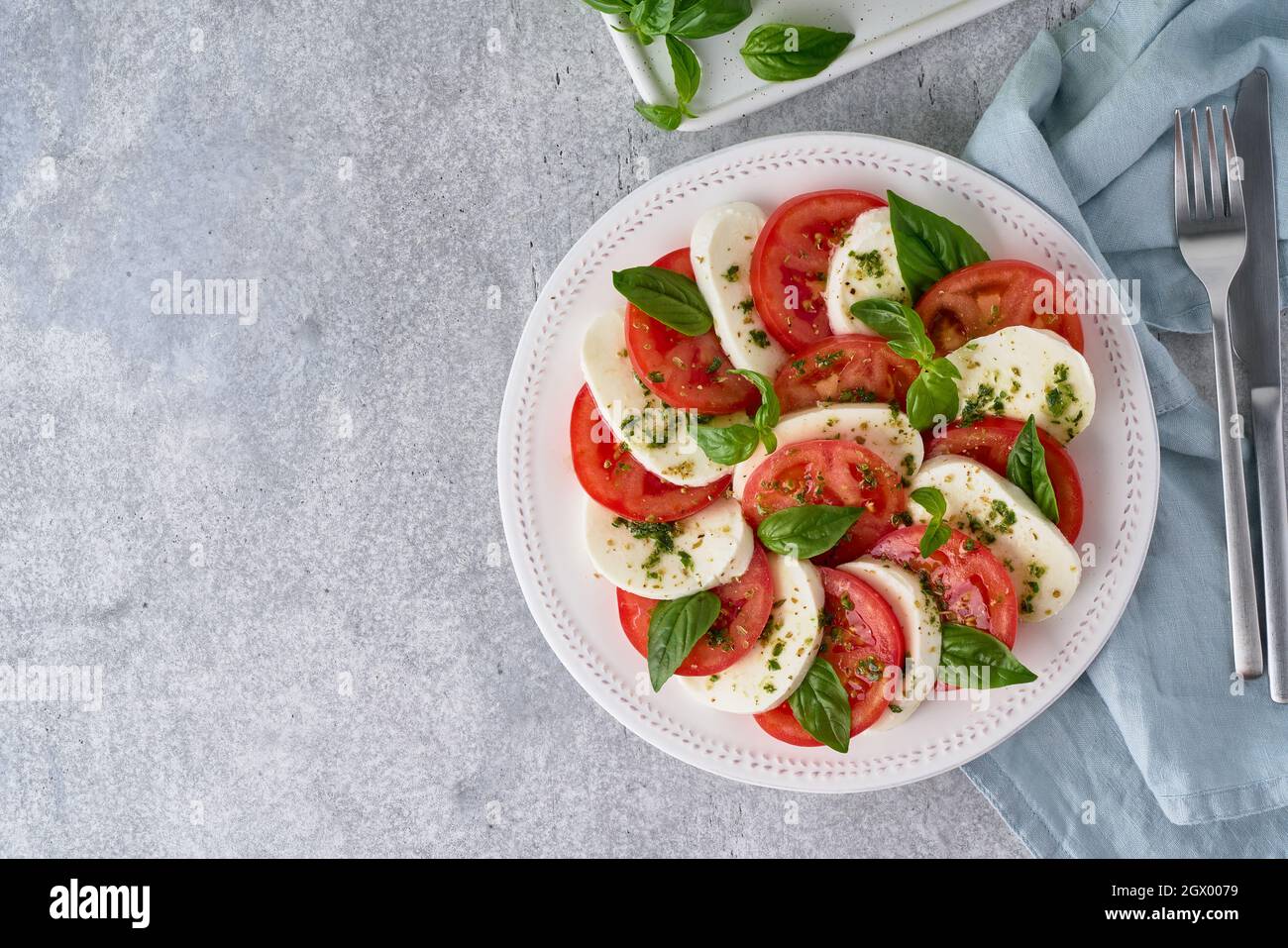 Traditional italian caprese salad with mozarella, tomatoes, basil, oil ...