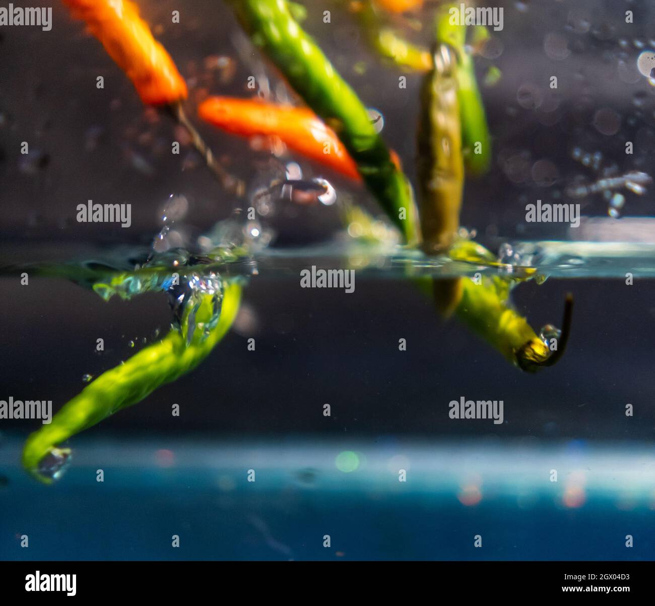 Multicolor fresh chili peppers falling hi-res stock photography and ...