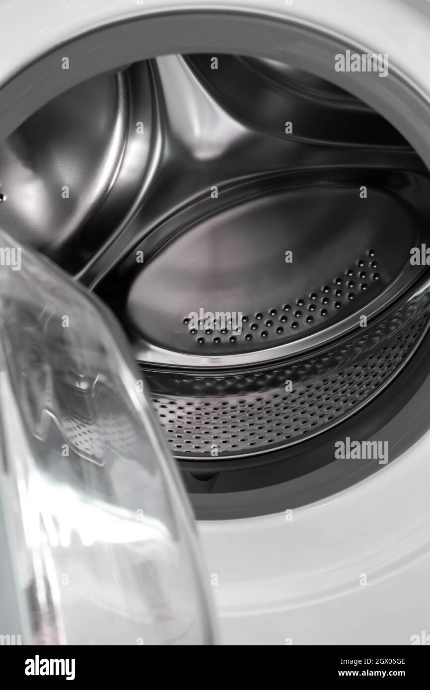 Chromed drum of a washing machine with an open lid Stock Photo - Alamy