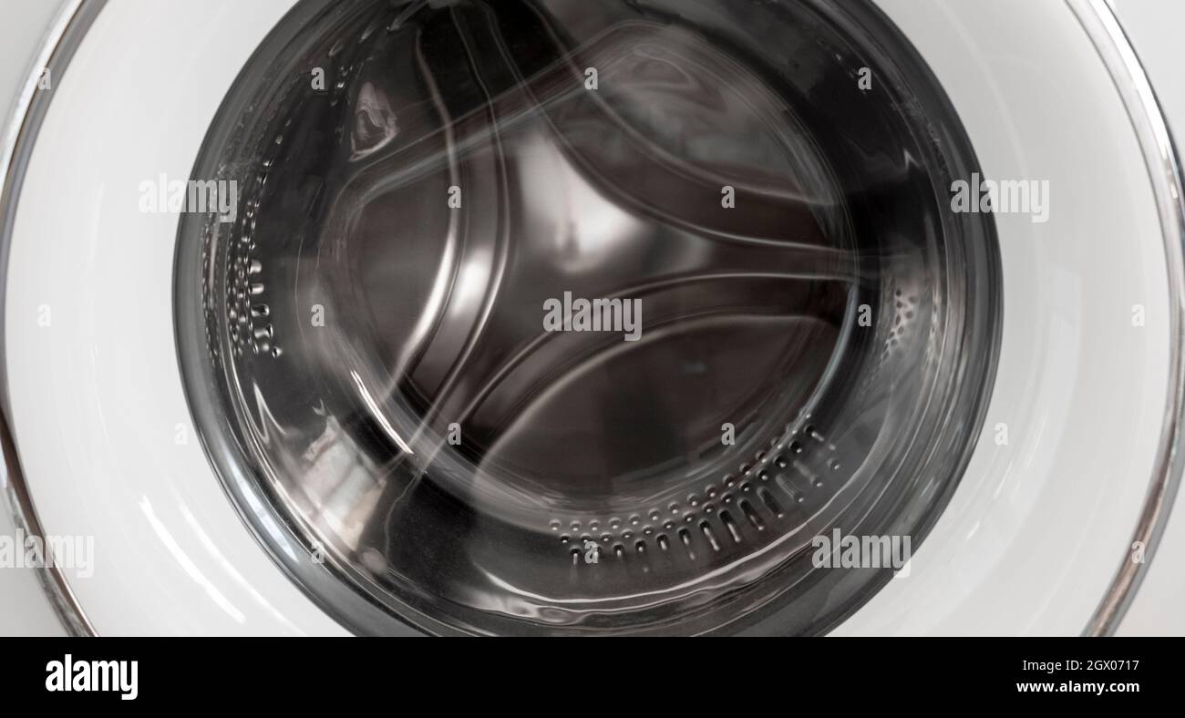 Chromed drum of a washing machine with an open lid Stock Photo - Alamy