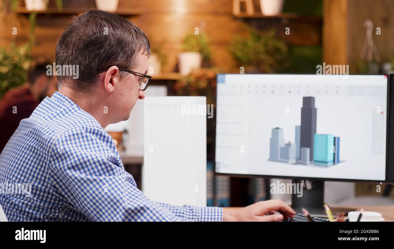 Engineer man working at architectural building prototype on computer ...