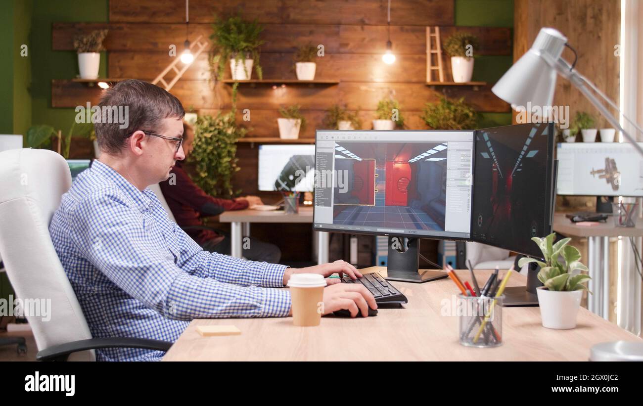 Game creator developing videogame simulation while working at level ...