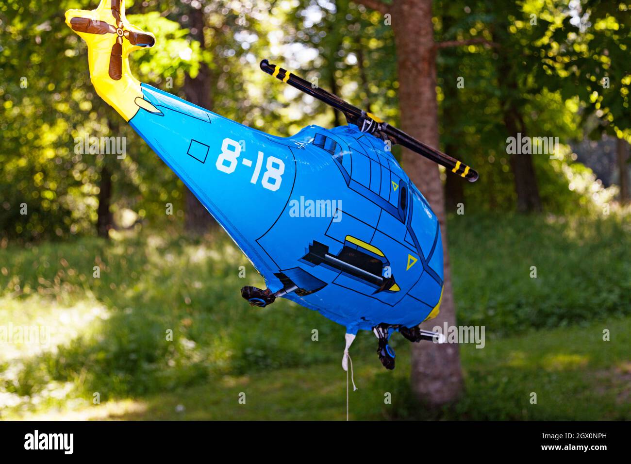 helium balloon depicting a blue helicopter Stock Photo - Alamy