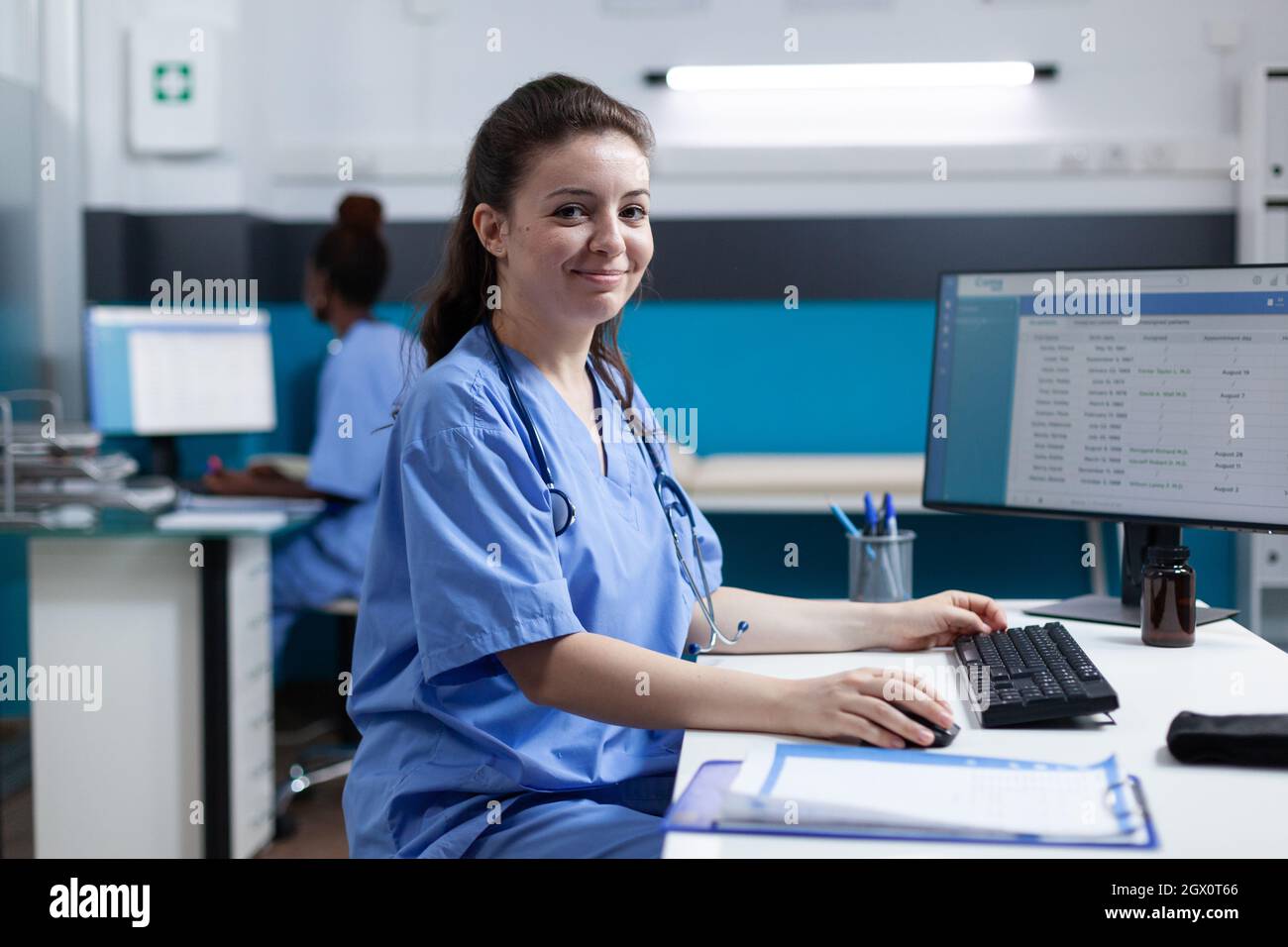 Portrait of pharmacist nurse typing medical prescription checking ...