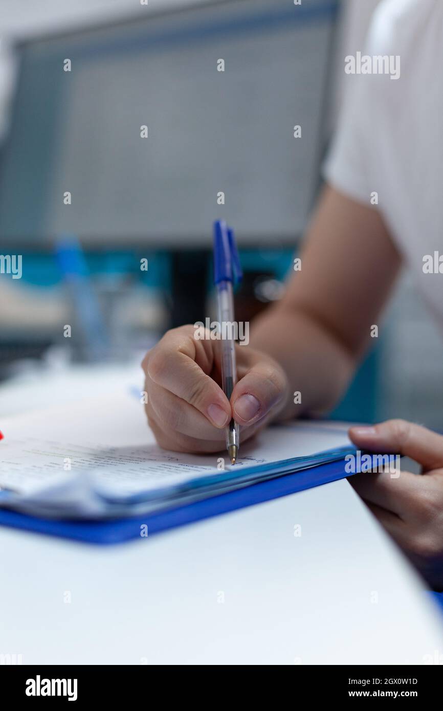 Closeup of woman patient signing medical documents during clinical ...