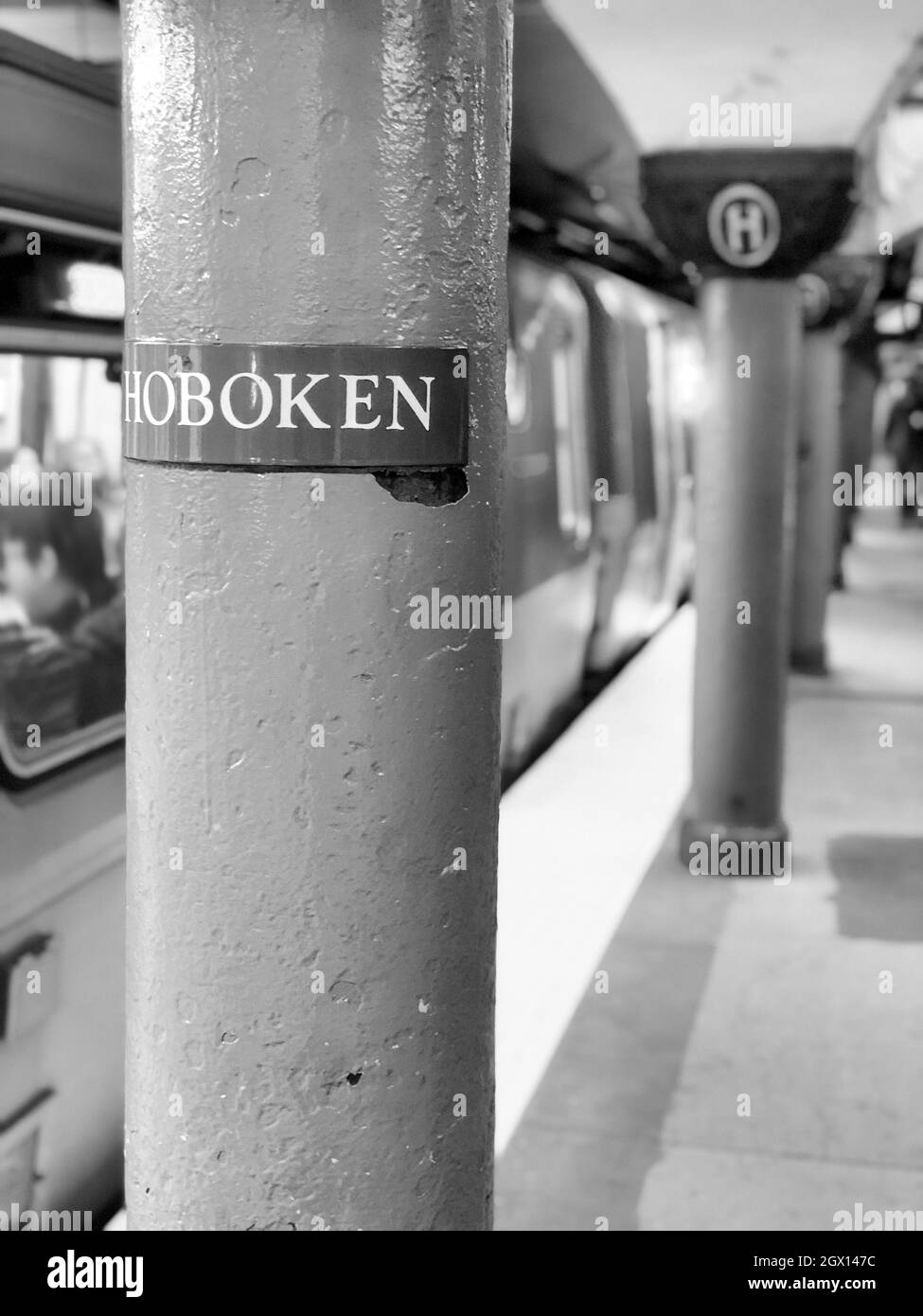 Grayscale shot of a pillar of Hoboken subway train station in New ...