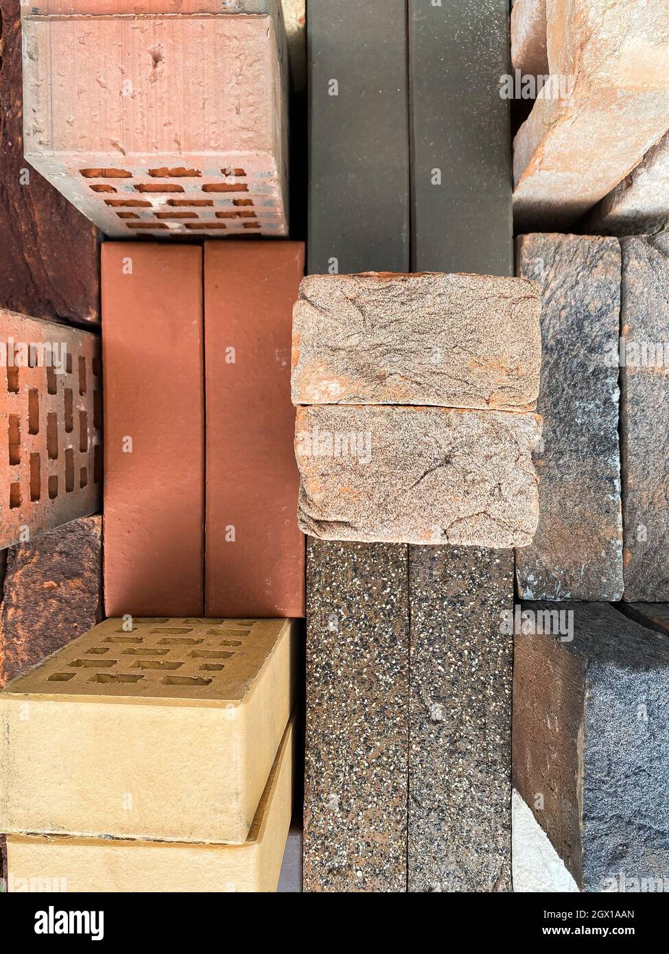 Different types of bricks stacked beautifully on green grass. Top view ...