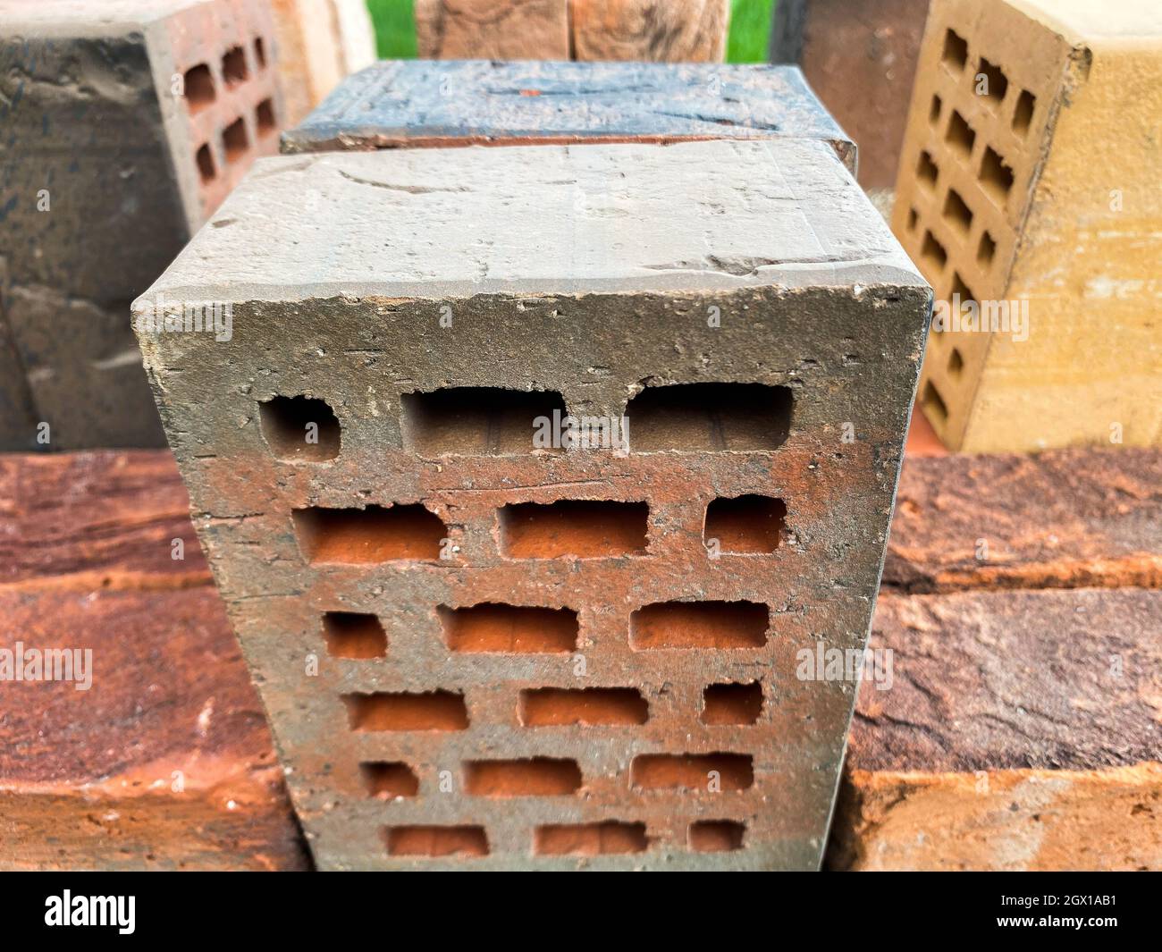 Different types of bricks stacked beautifully on green grass Stock ...