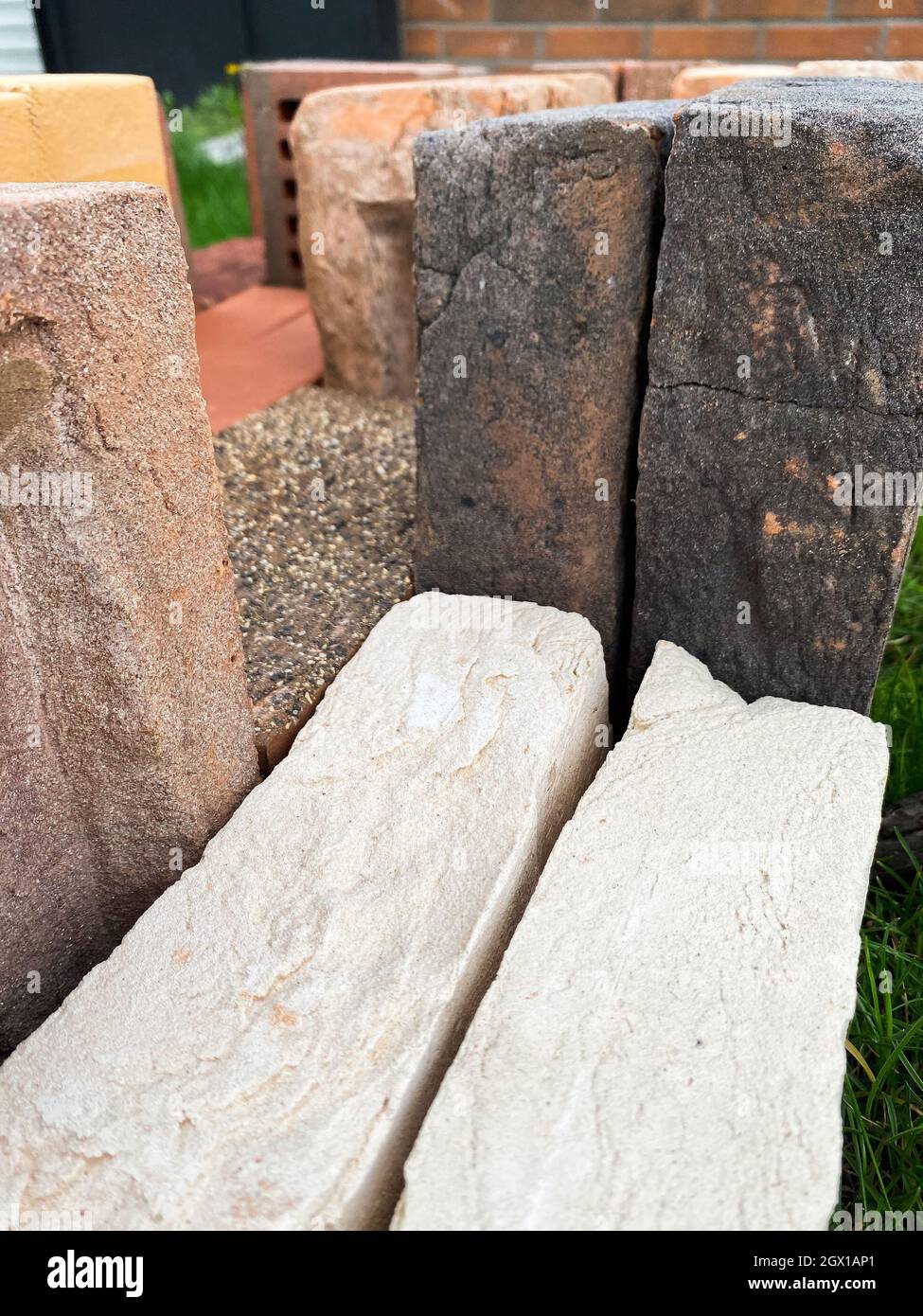 Different types of bricks stacked beautifully on green grass Stock ...
