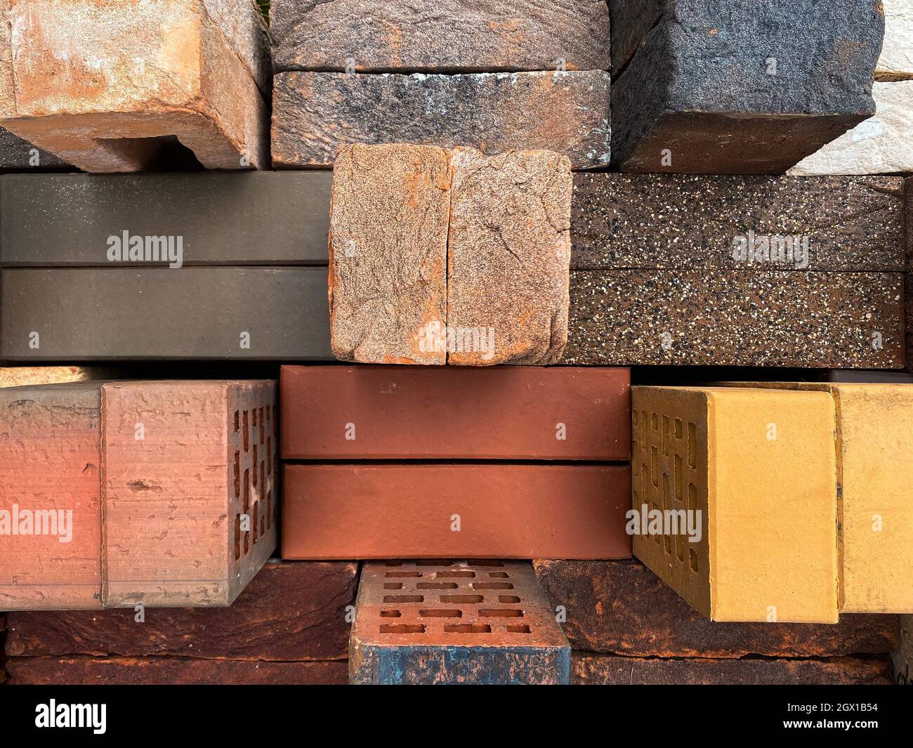 Different types of bricks stacked beautifully on green grass. Top view ...