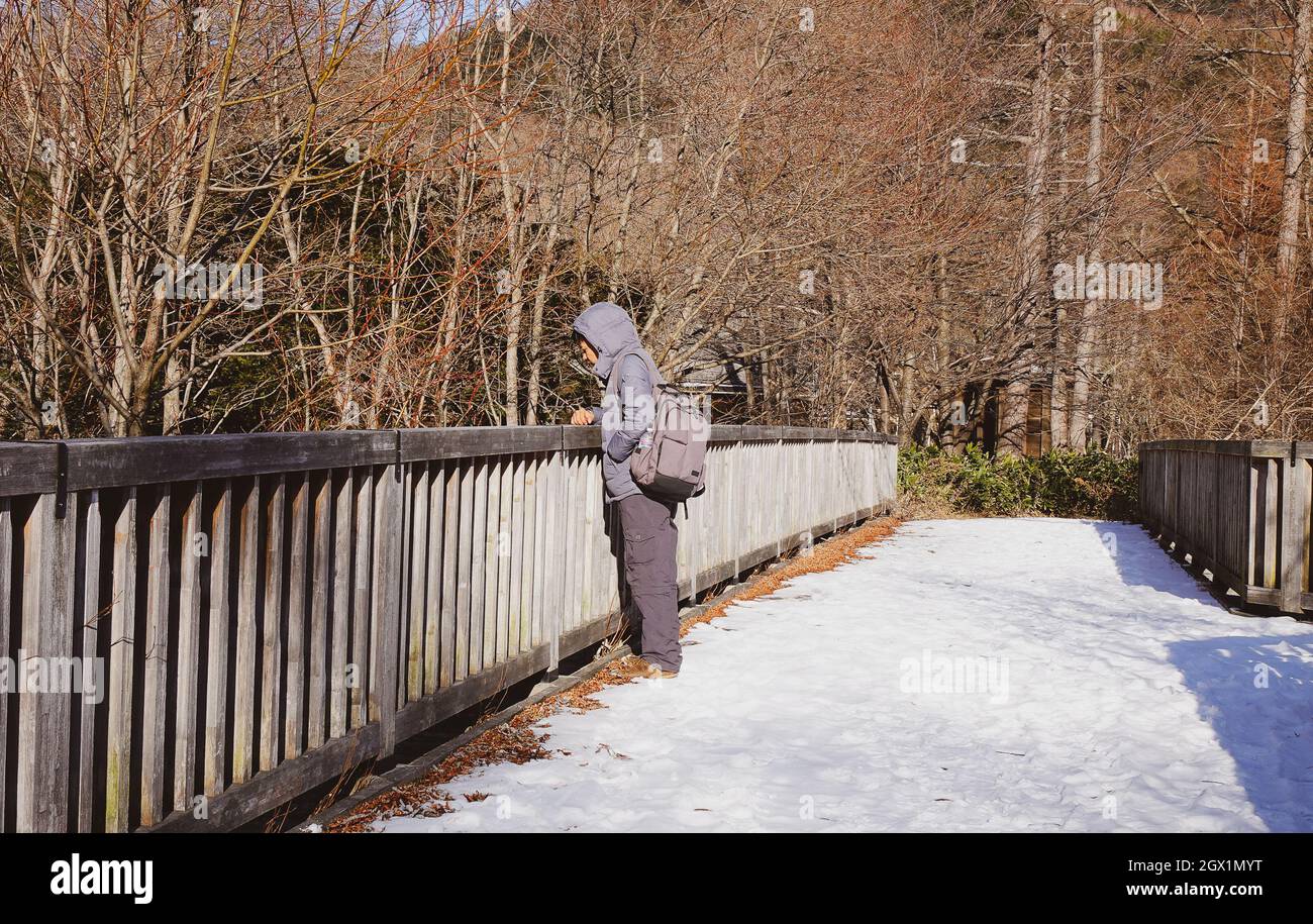 Traveler at winter forest of Nikko, Japan. Nikko is famous for its ...