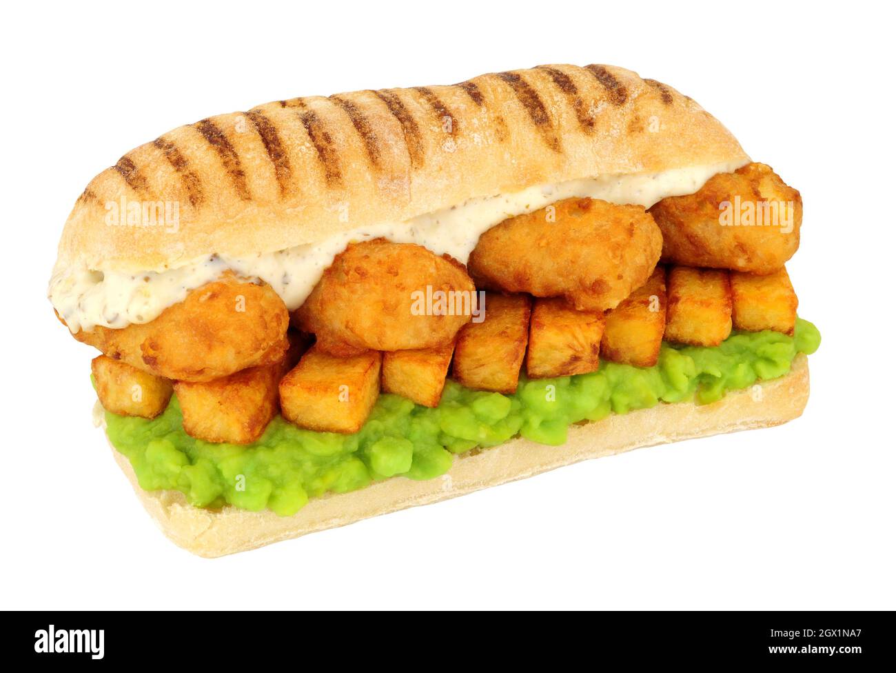 Fish and chips sandwich with battered cod fish and mushy peas in a ...