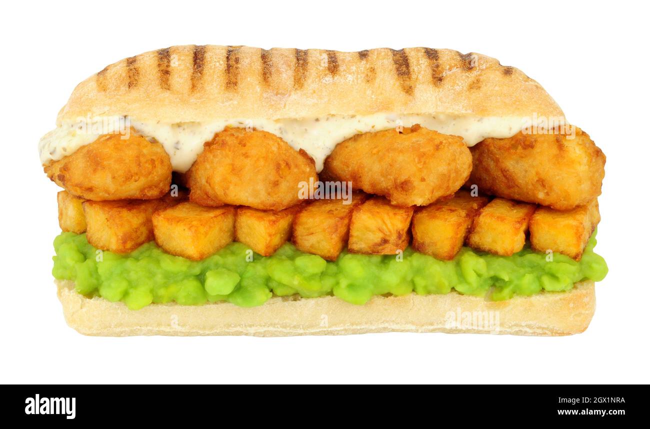 Fish and chips sandwich with battered cod fish and mushy peas in a ...