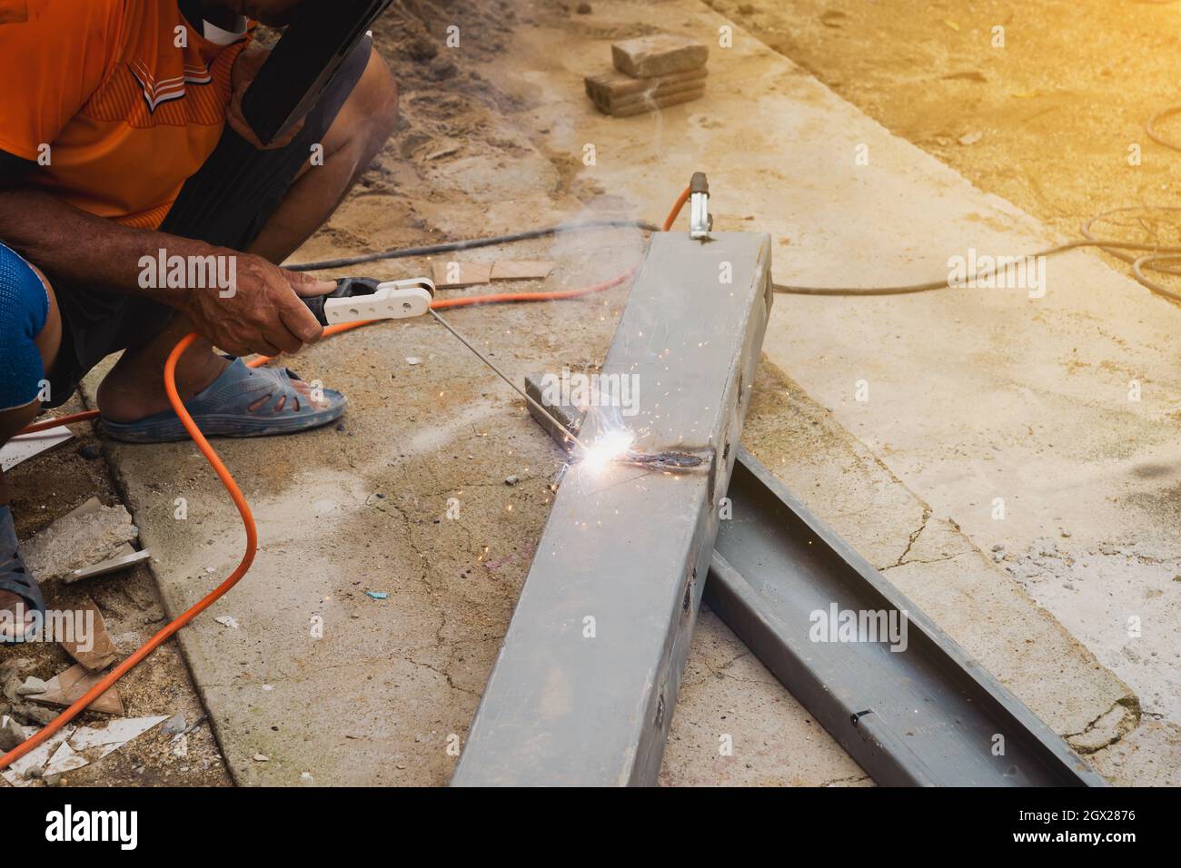 Man welder doing a metal staircase structure in a residential building ...