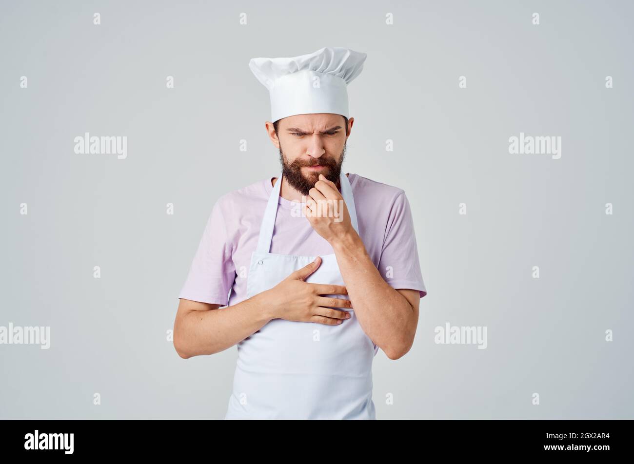 a bearded man in a chef's uniform gestures with his hands the emotions ...
