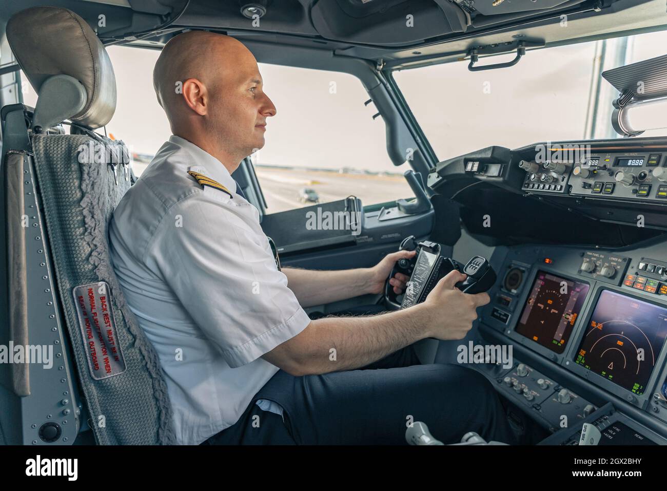 Attractive commercial pilot in cockpit hi-res stock photography and ...