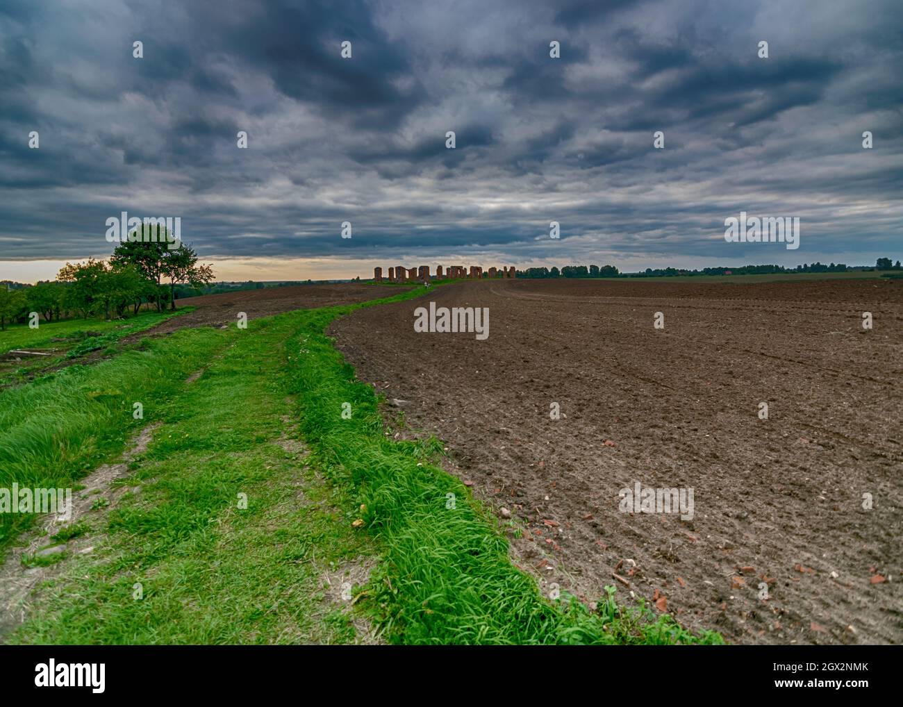 landscape with stone and brick barn ruins reminiscent of one of the ...