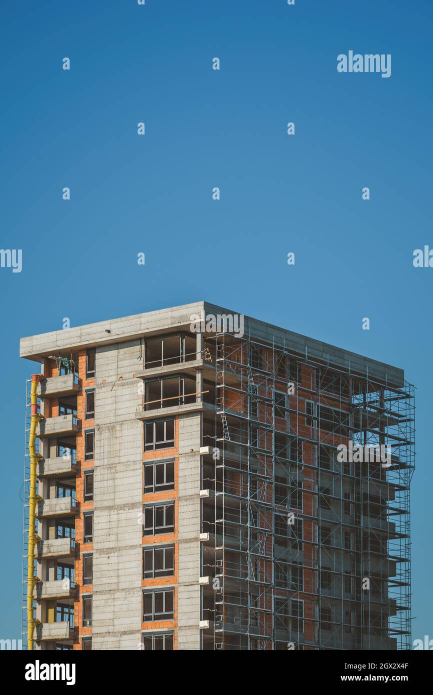 High-rise skyscraper building under construction with sky as copy space ...