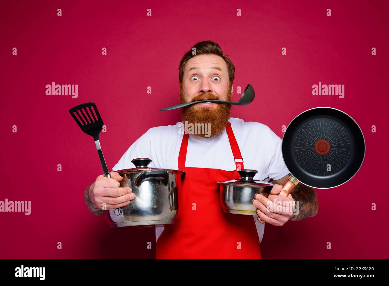 scared chef with beard and red apron is ready to cook Stock Photo - Alamy