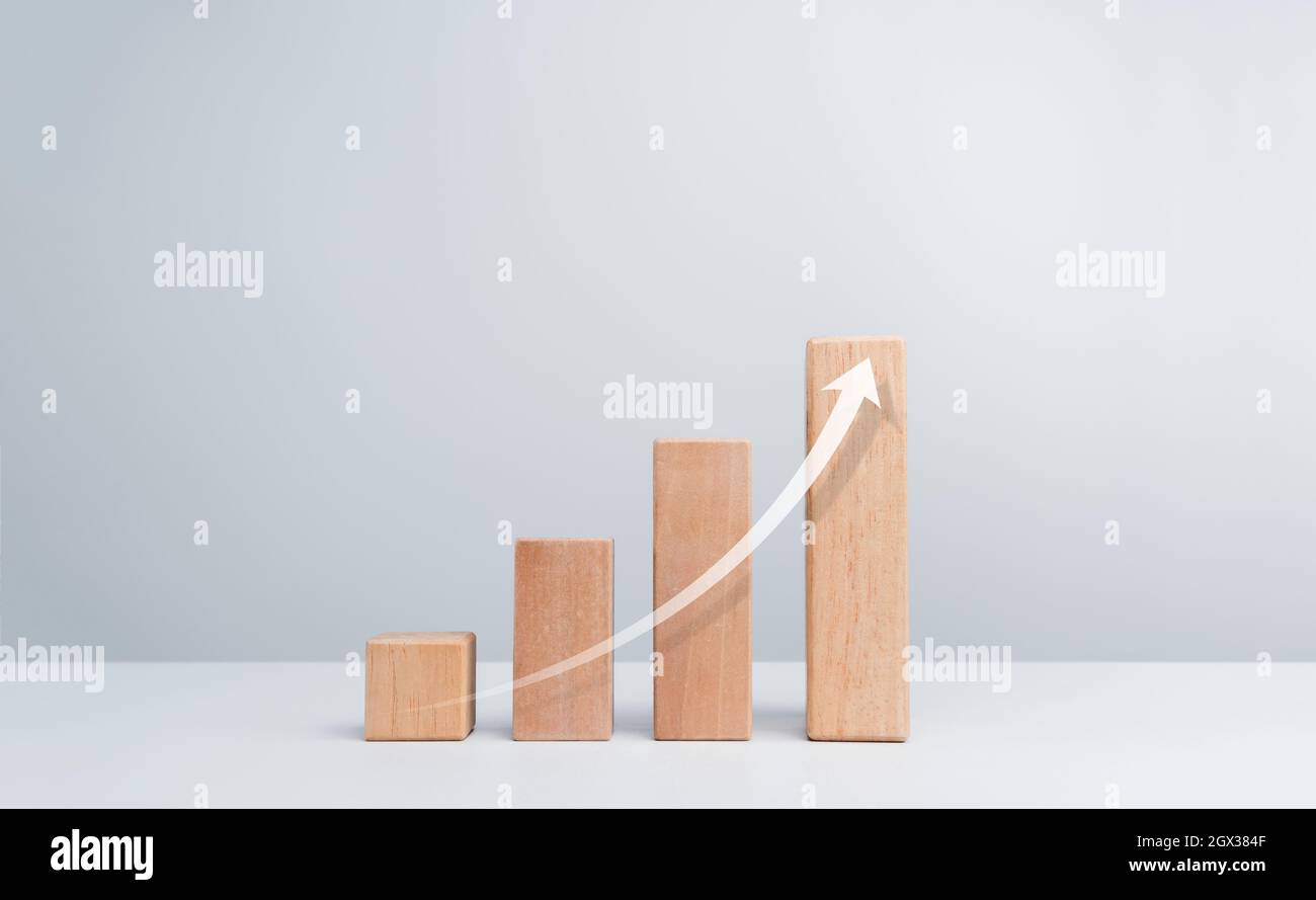 Rise up arrow on wooden blocks chart steps on a white clean background ...
