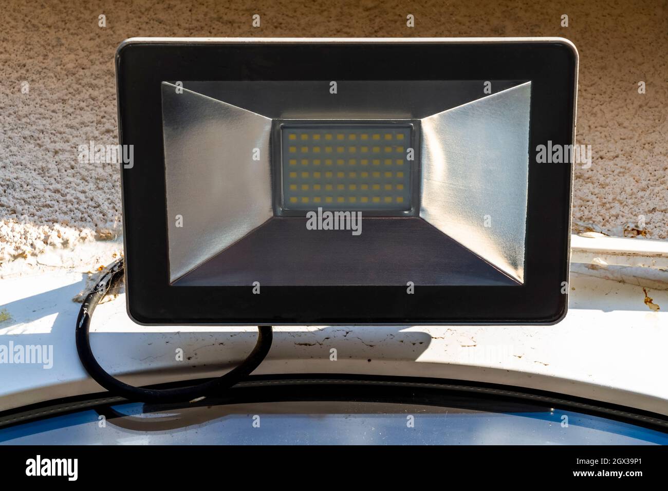 The LED garden searchlight hangs over the entrance to the private house ...