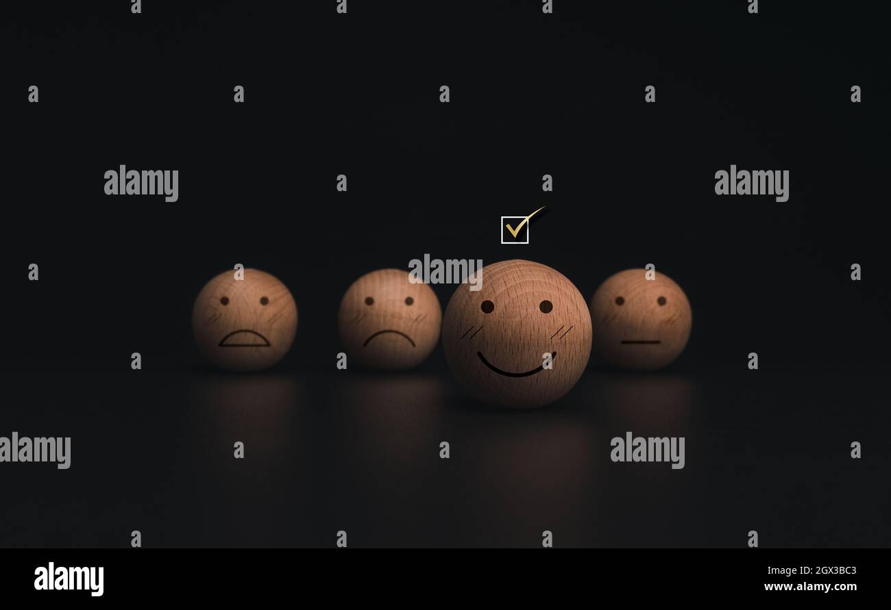 Check mark a checkbox on smiley emoticon face on the wooden balls on ...