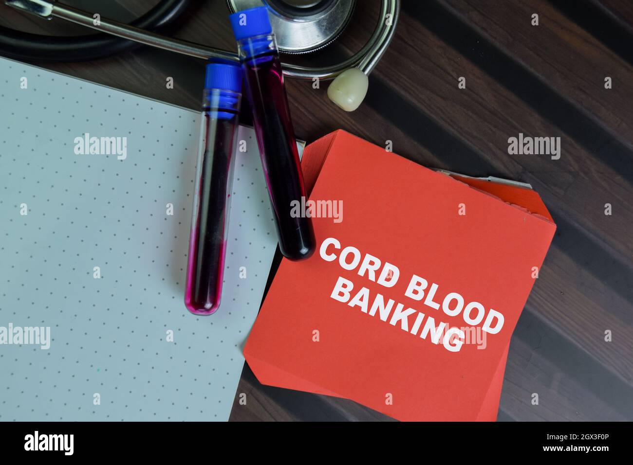 Cord Blood Banking write on sticky notes isolated on Wooden Table Stock ...