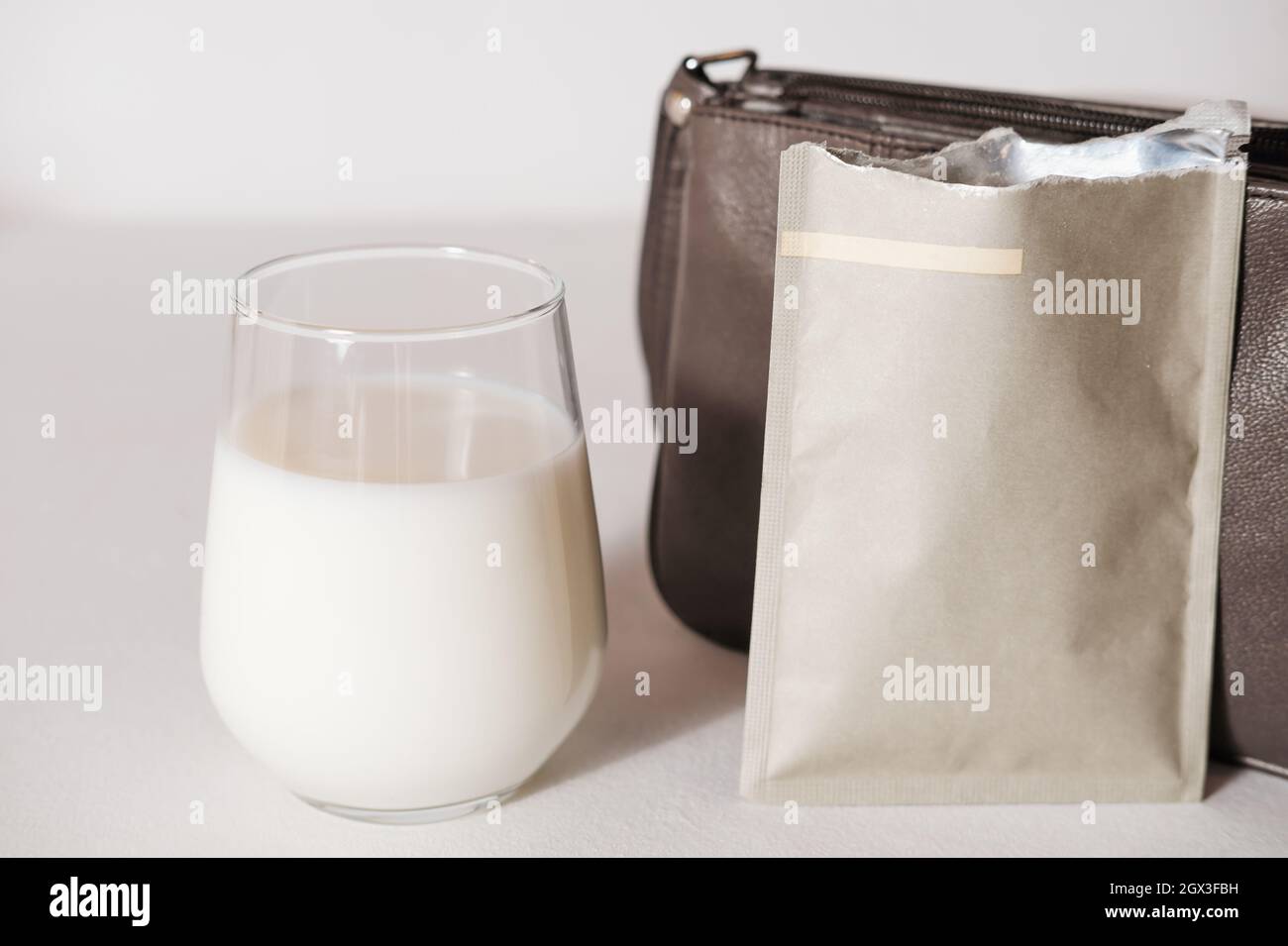collagen powder travel pack and a glass of milk to make protein ...