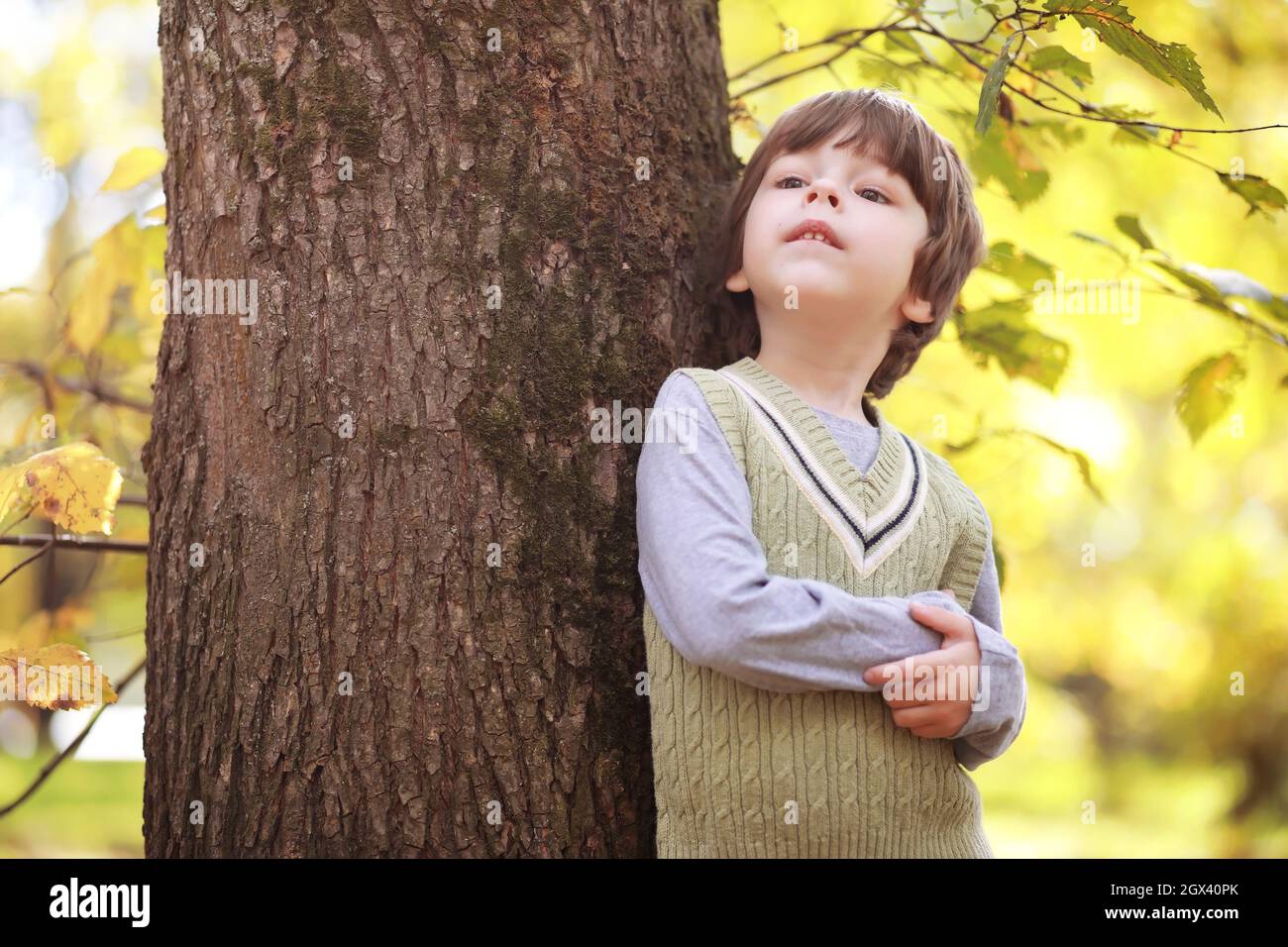 Children with briefcases for a walk in park. School break. The ...