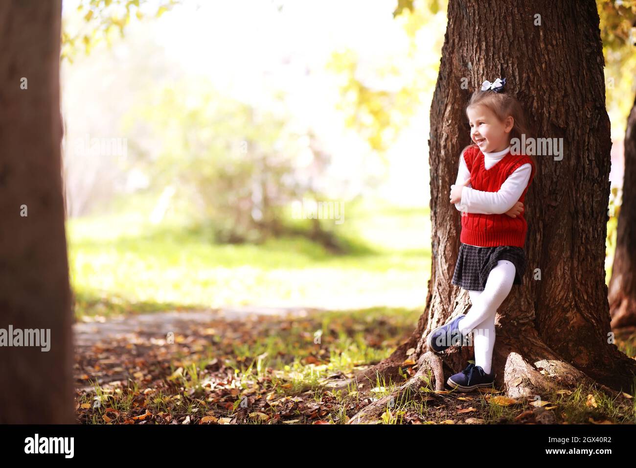 Children with briefcases for a walk in park. School break. The ...