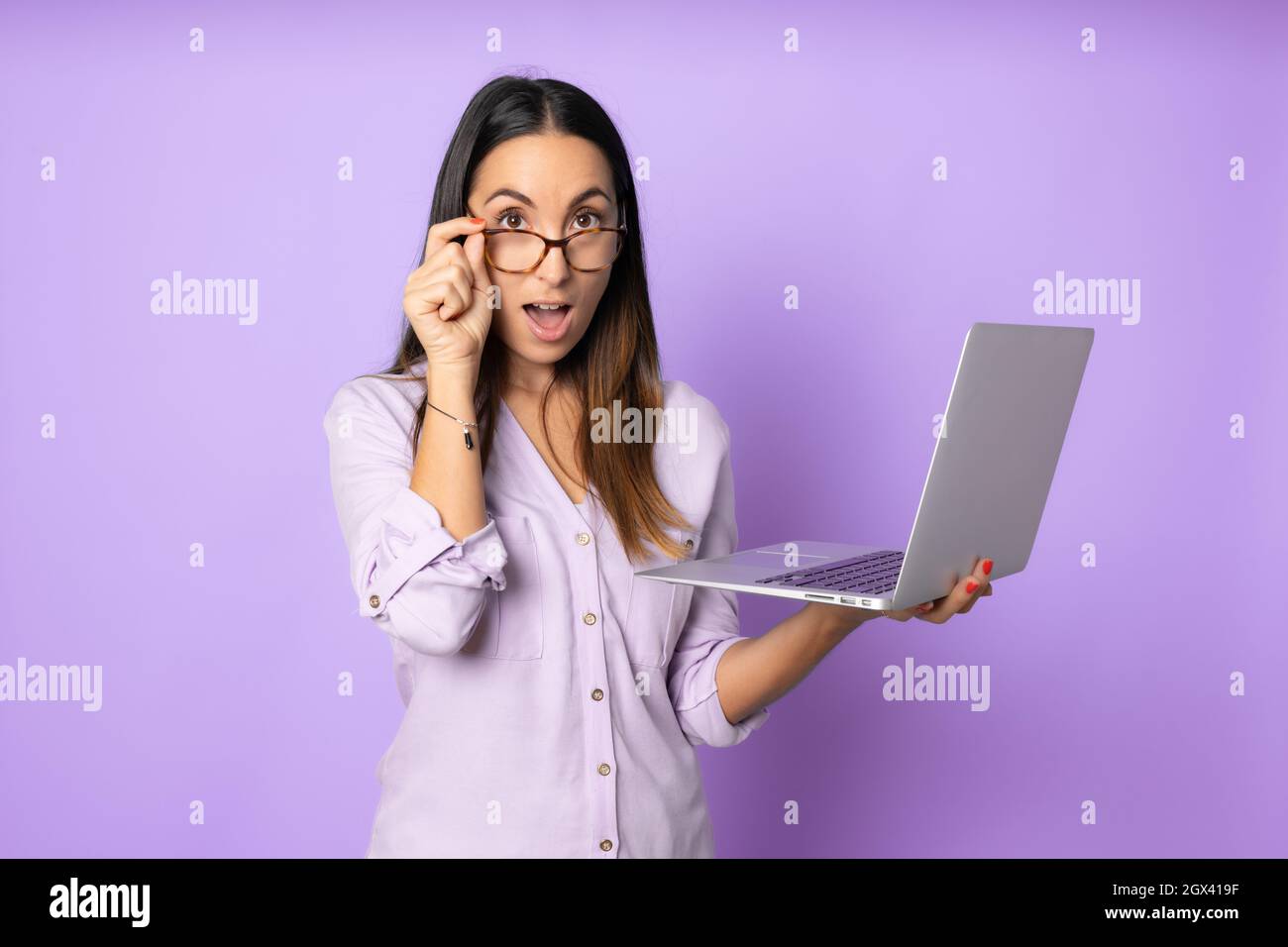 Image of shocked young lady student standing isolated over purple wall ...
