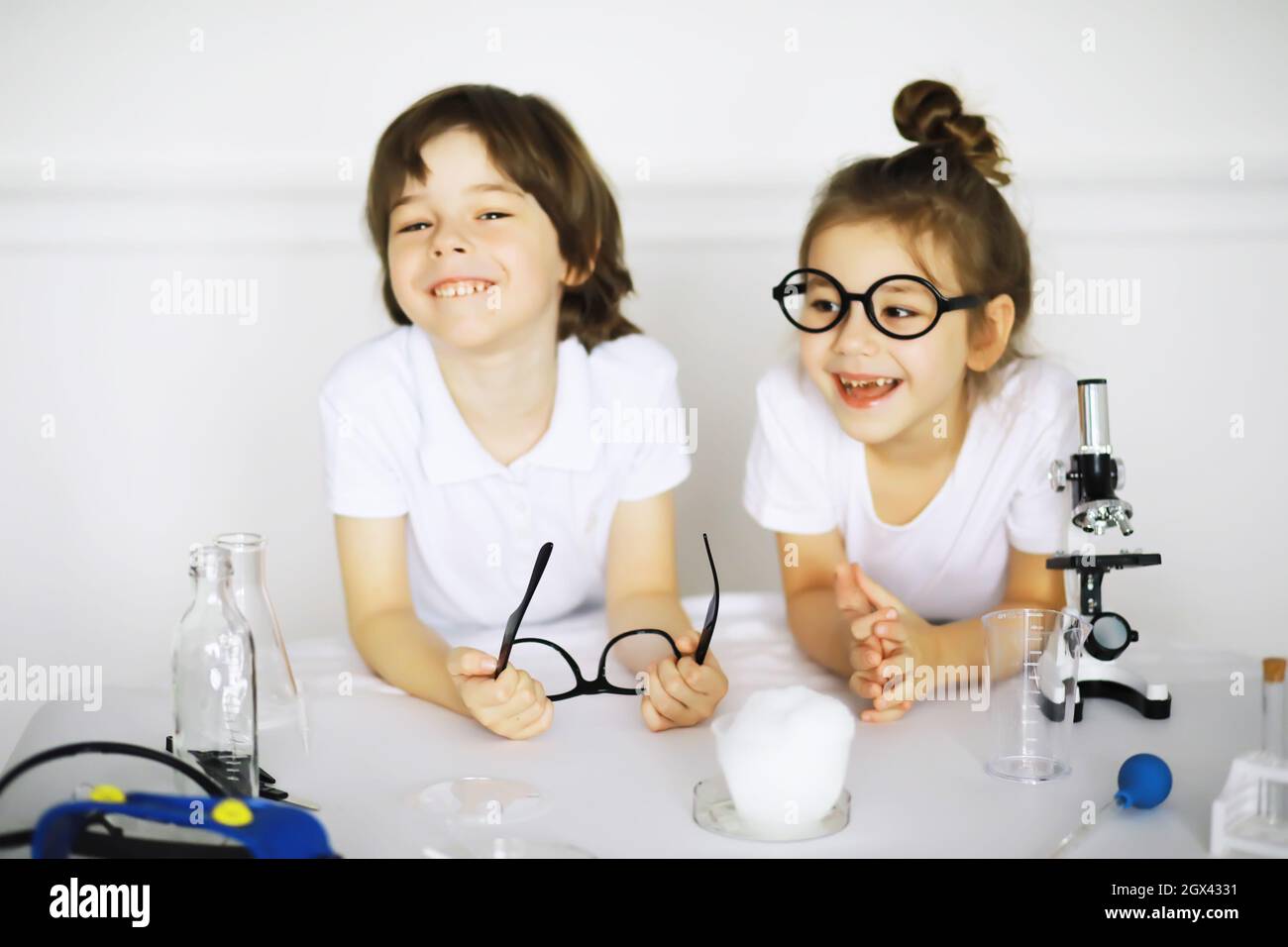 Two cute children at chemistry lesson making experiments isolated on ...