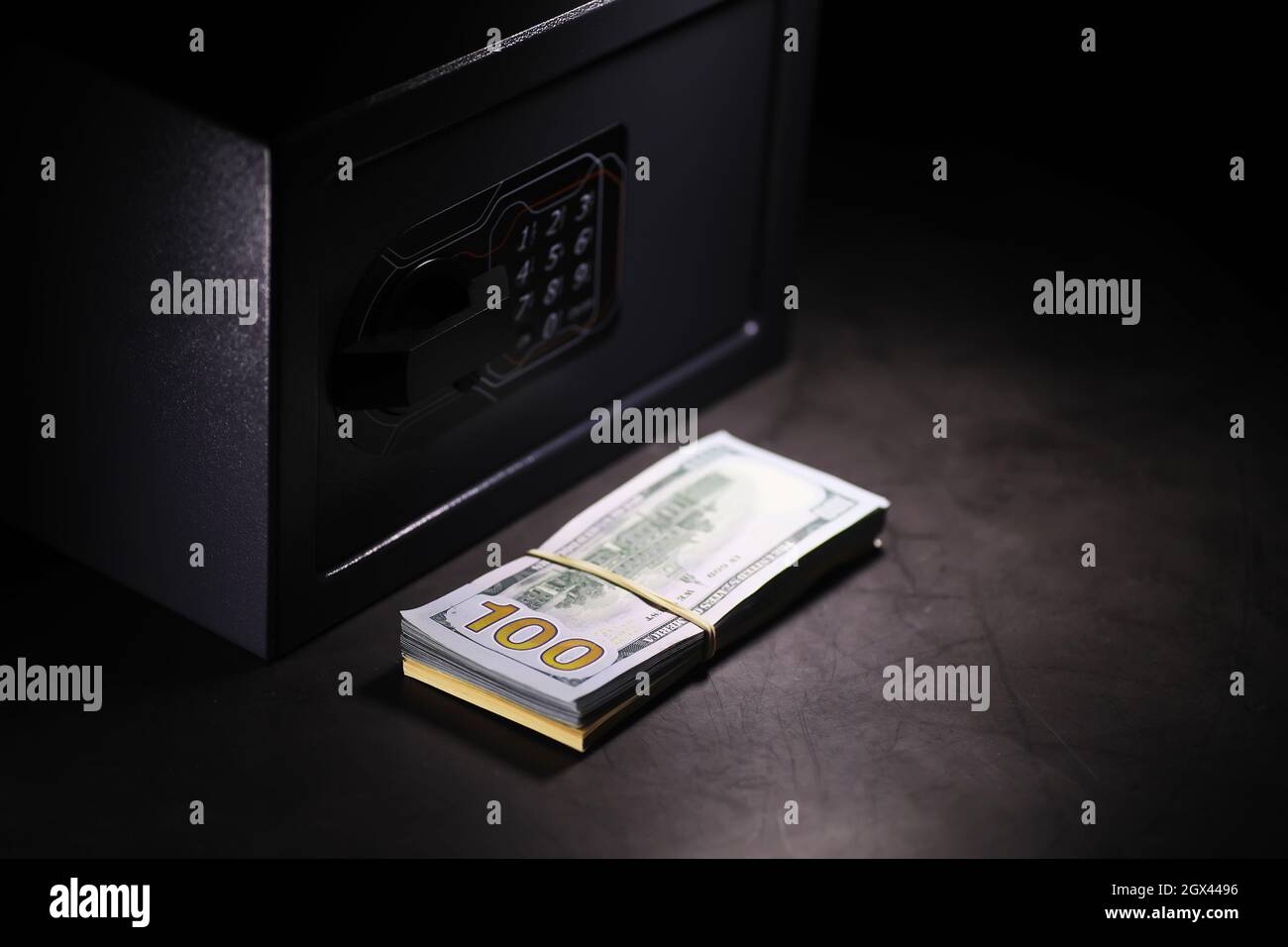 Steel safe with money. Hand putting password in the safety money box in ...