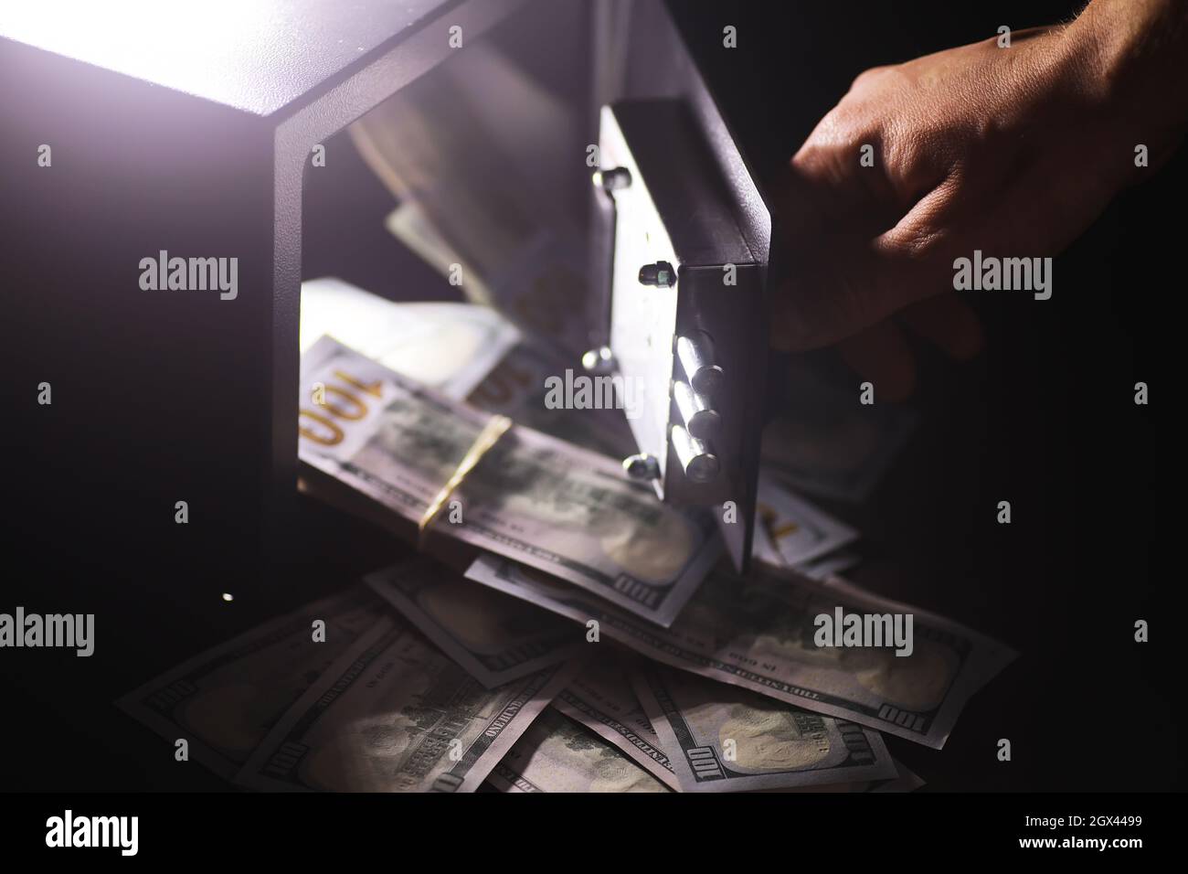 Steel safe with money. Hand putting password in the safety money box in ...