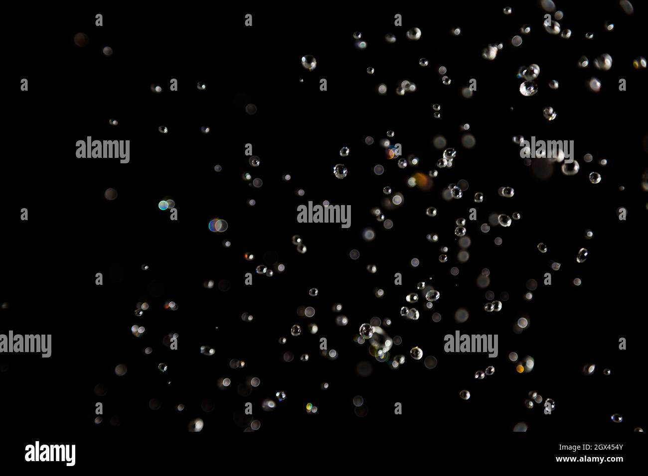 bokeh of water drops levitating in the air reflection with light Stock ...