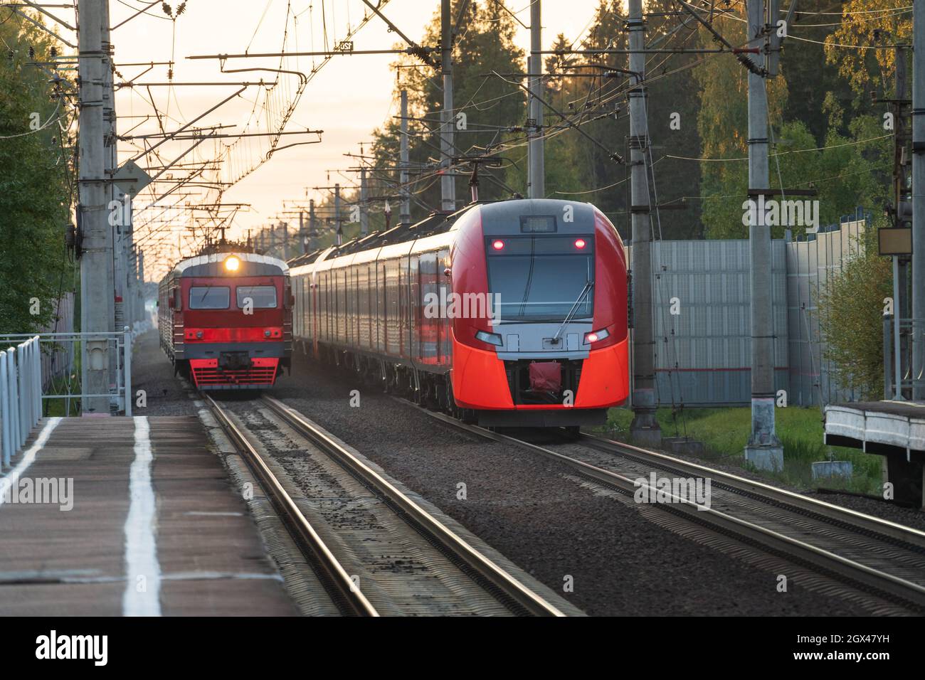 Russian old commuter and high-speed electric train on railroad at ...
