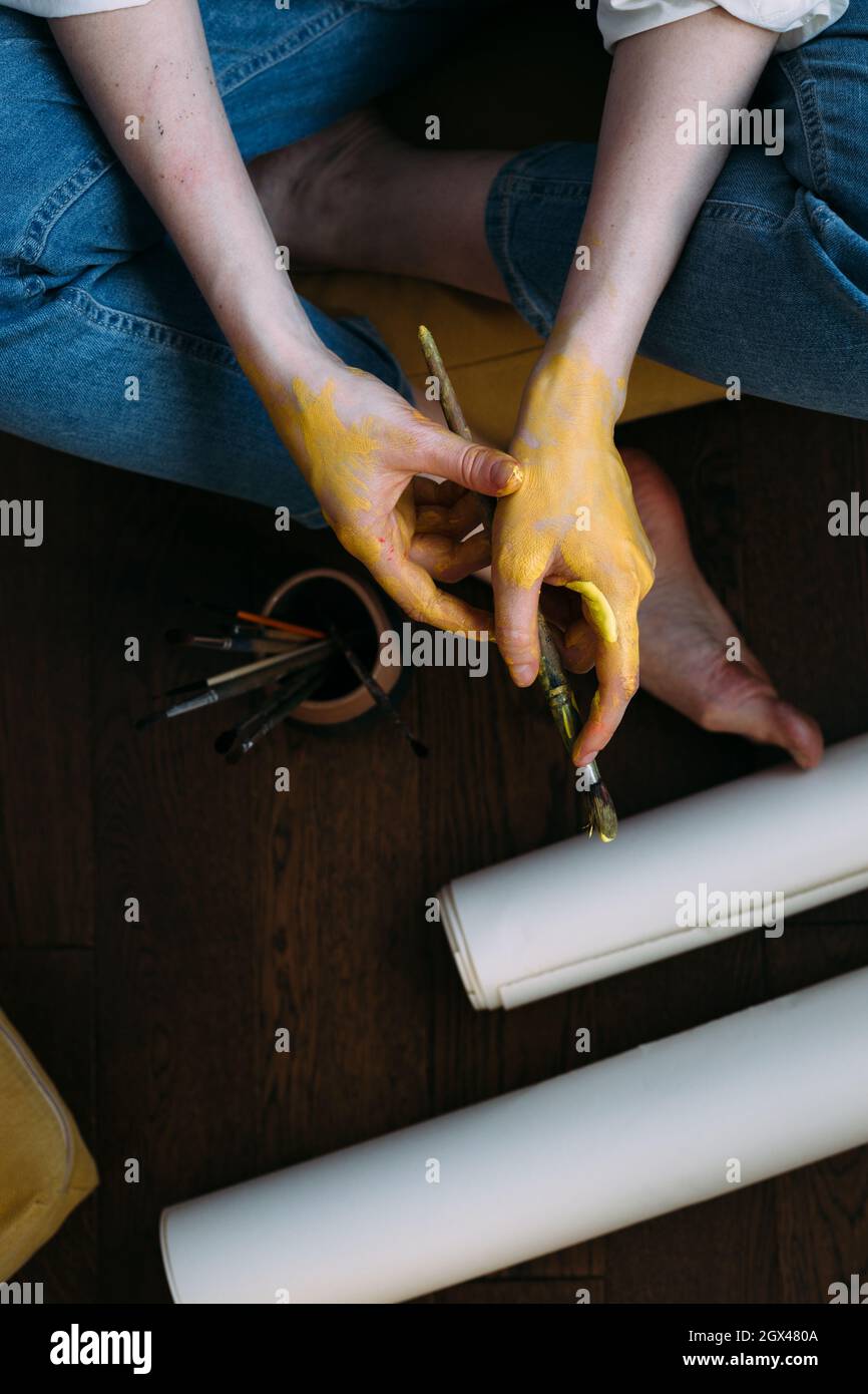 Female hands hold paint brushes. Painting a picture on an easel Stock ...