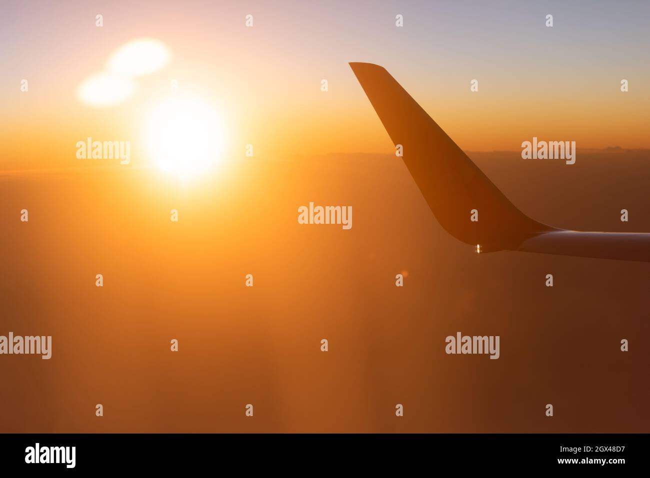 Sunrise view from airplane window seat. Shining sun with lens flare ...