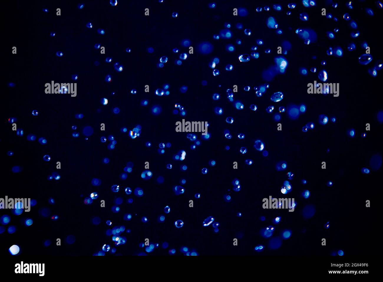 defocus bokeh of water drop on blue background Stock Photo - Alamy