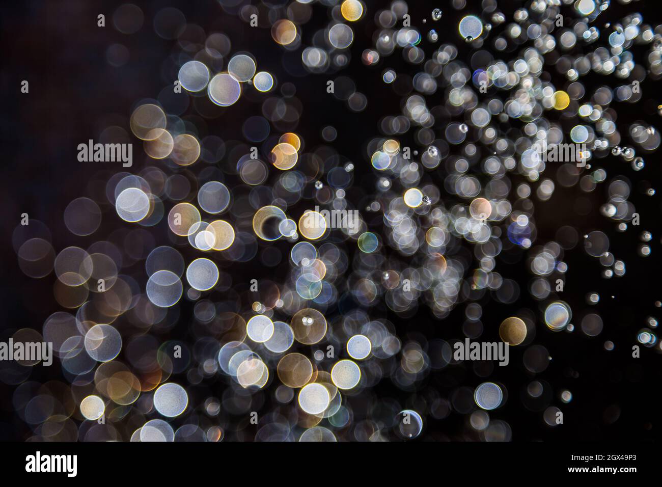 bokeh of water drops levitating in the air reflection with light Stock Photo - Alamy