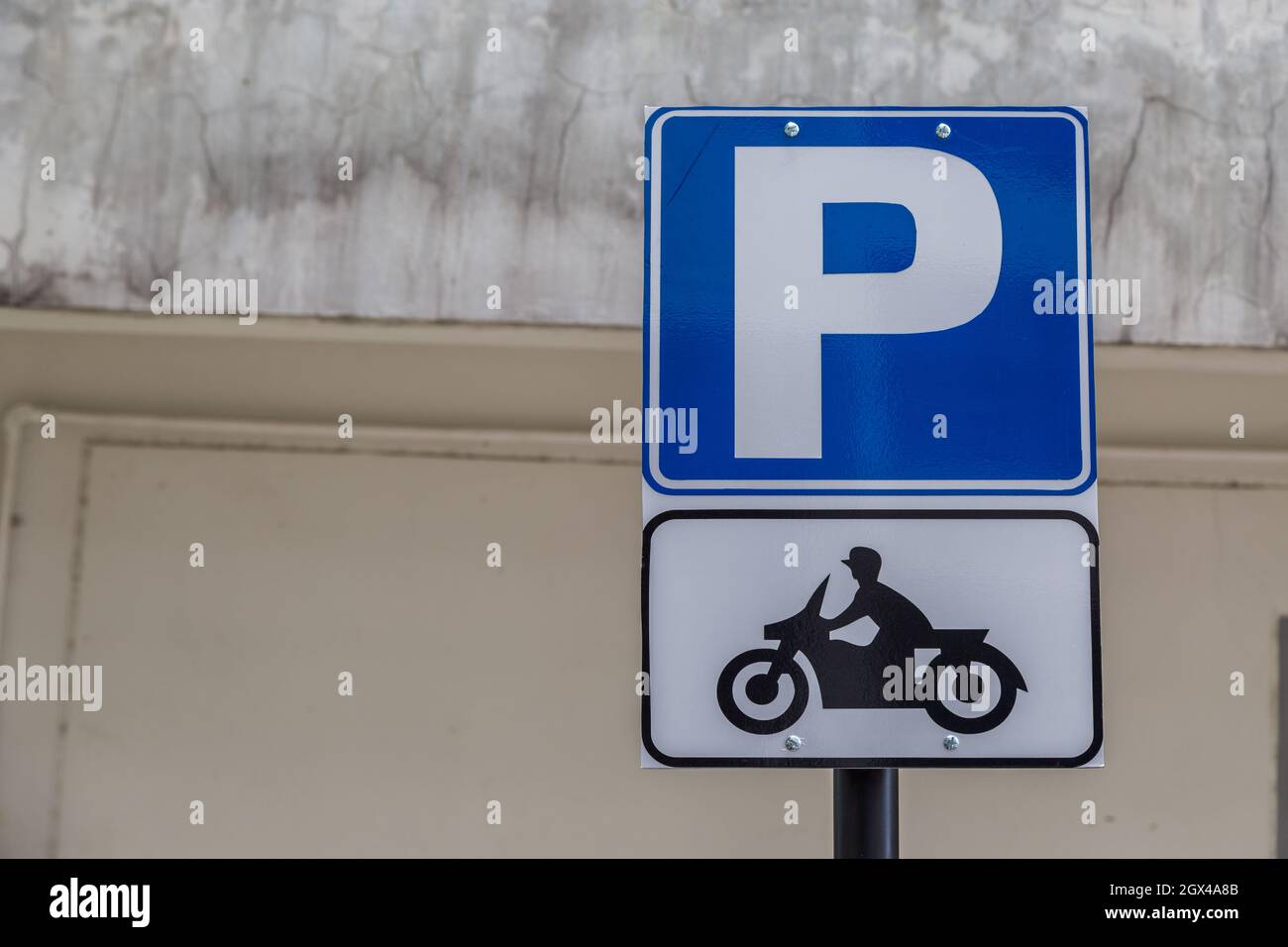 Blue Sign of motorbikes parking background Stock Photo - Alamy