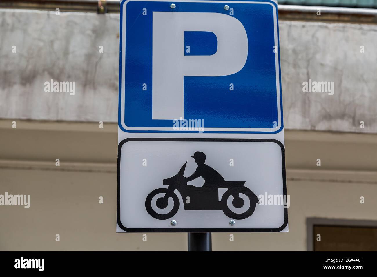 Blue Sign of motorbikes parking background Stock Photo - Alamy