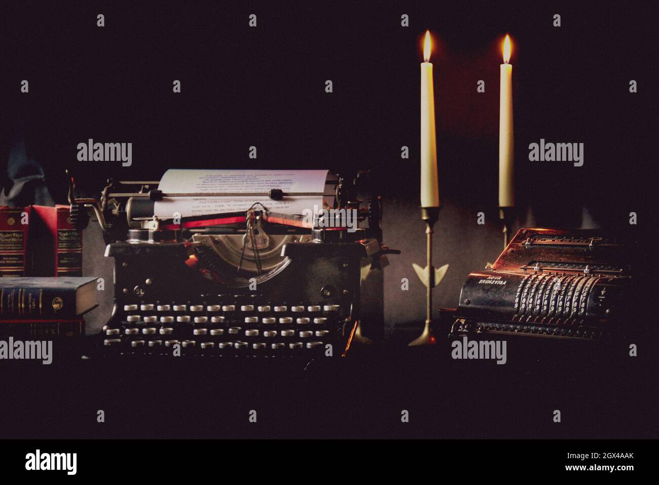 Classic typewriters with lighted candles at night Stock Photo - Alamy