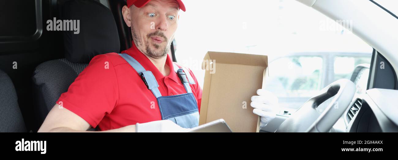 Courier driver opened box with the client parcel Stock Photo - Alamy