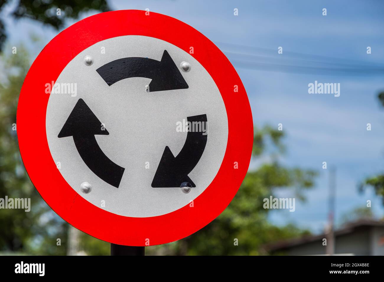 Roundabout Road Sign for Traffic with green bokeh background Stock ...