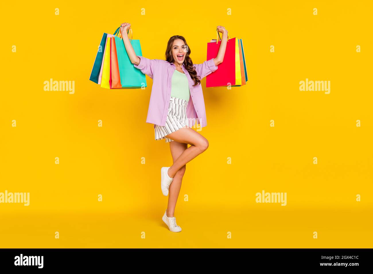 Full length body size photo careless woman jumping up keeping shopping ...