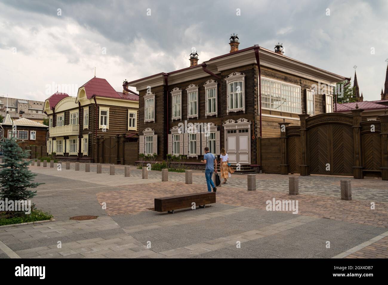 A young couple walk in the historic quarter of Gorky Street, past old ...