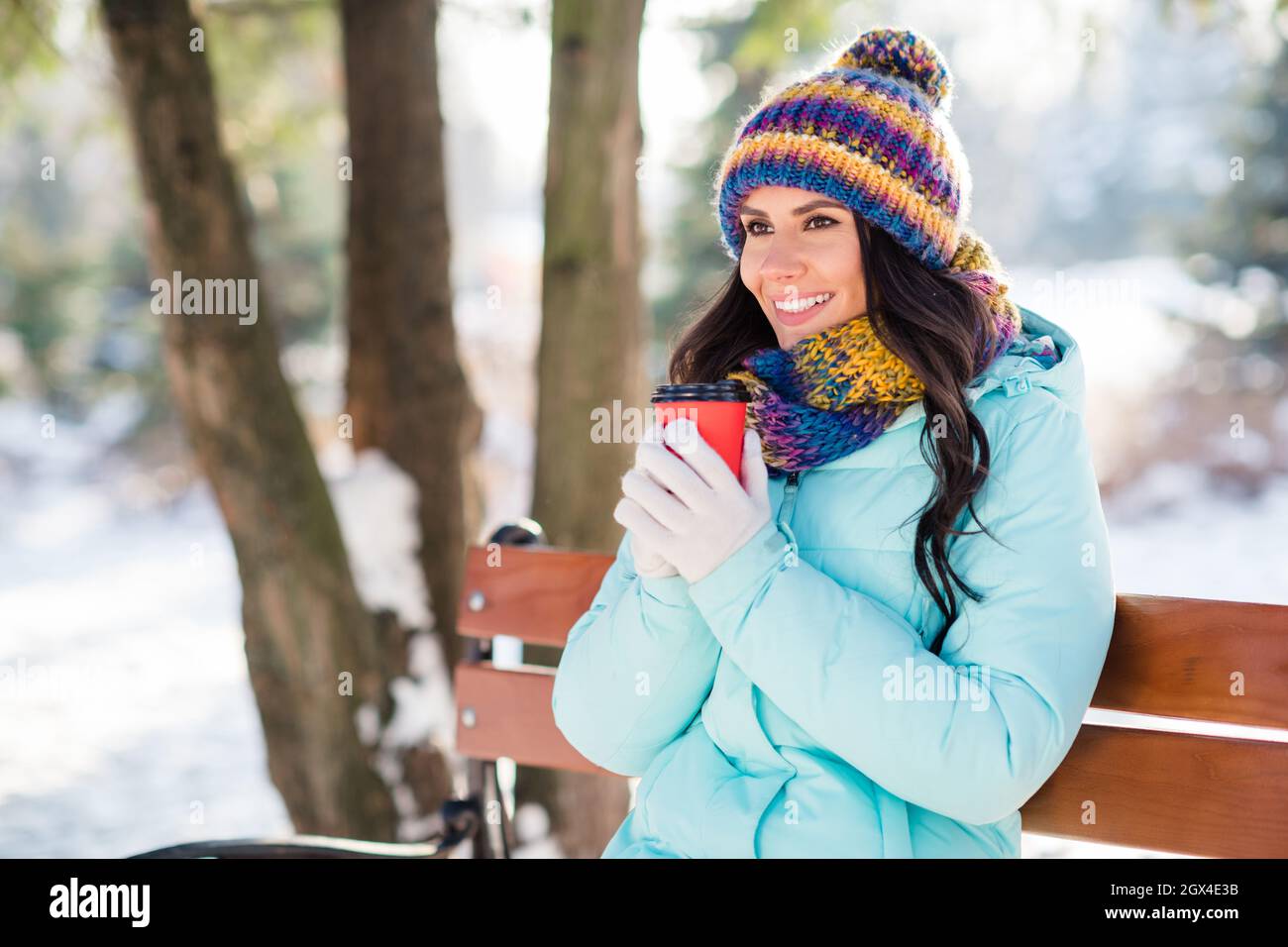 Photo of cheerful lady hold cup beaming smile wear hat scarf gloves ...